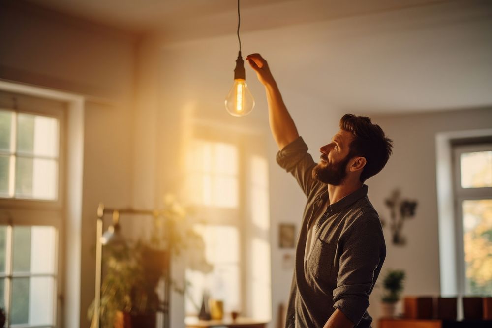 man changing light bulb hanging | Free Photo - rawpixel