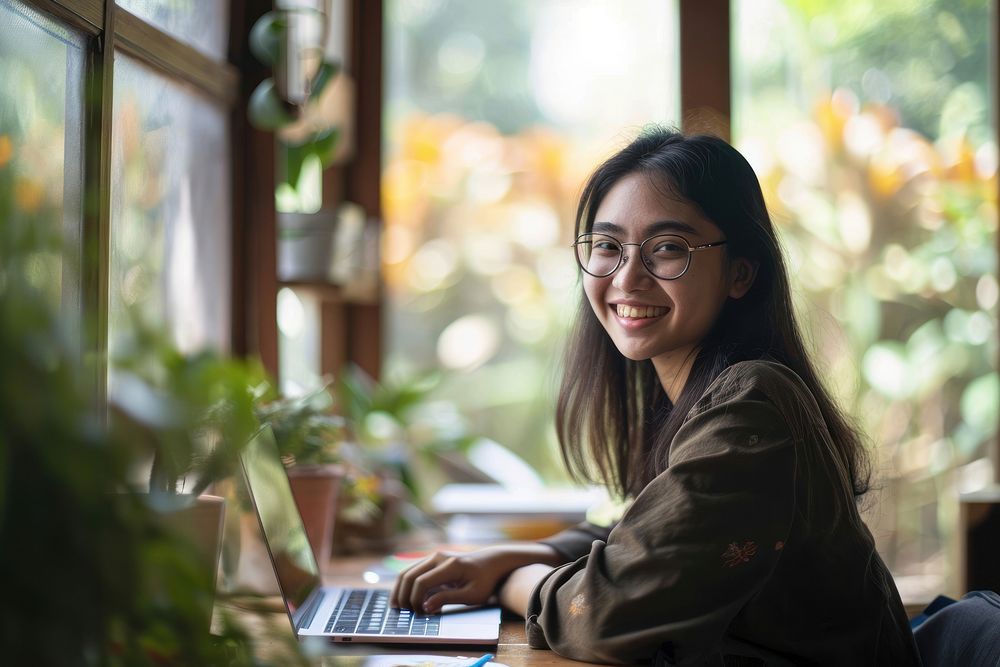 smiling girl doing work home | Free Photo - rawpixel