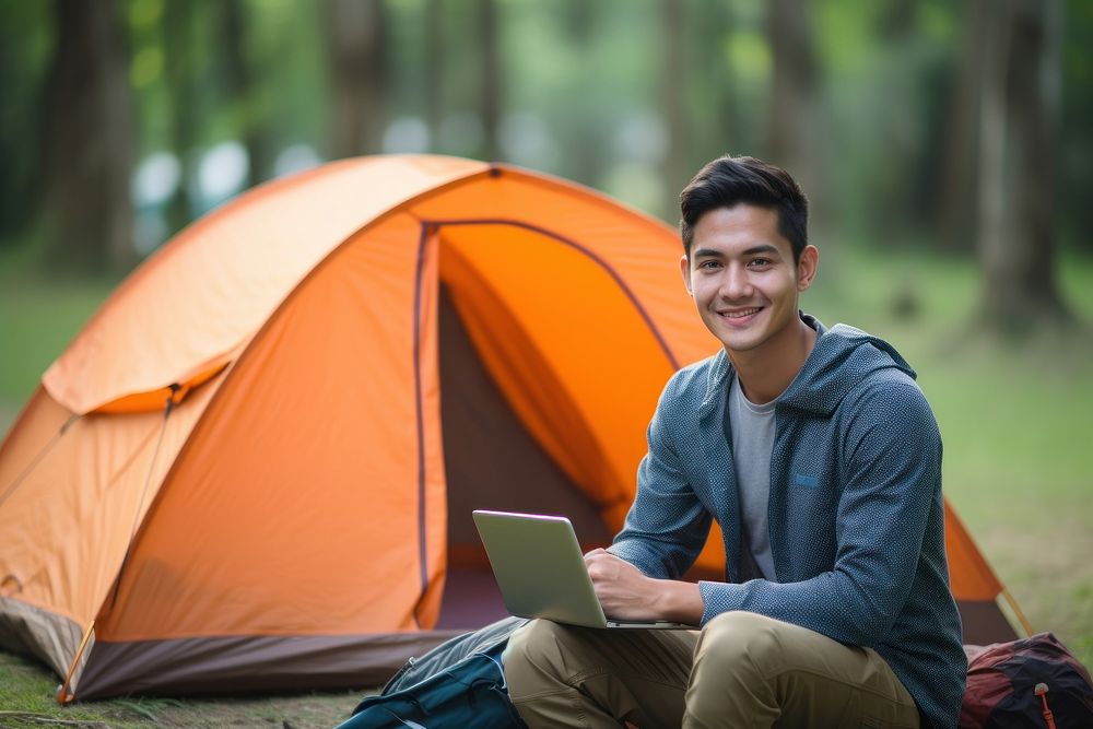 young man laptop front tent | Free Photo - rawpixel