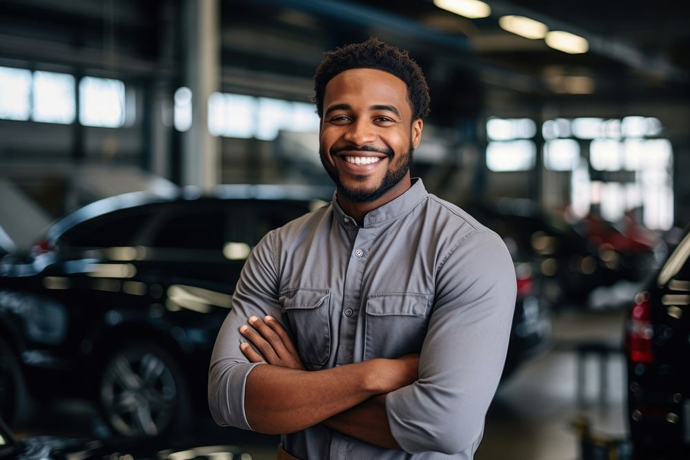 An automotive repair technician smiling | Free Photo - rawpixel