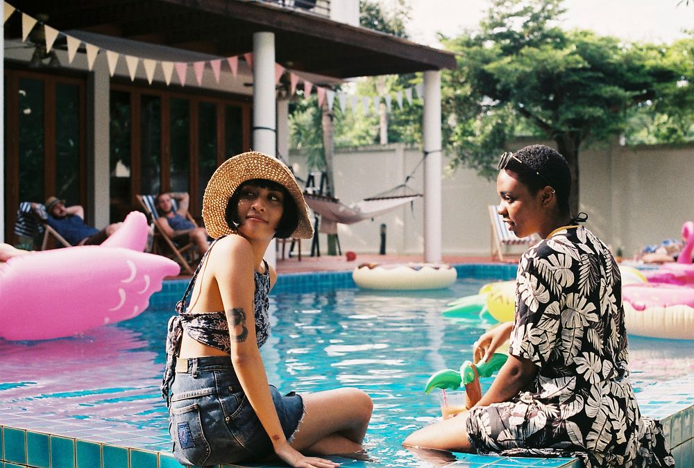 People sitting by the pool | Photo - rawpixel