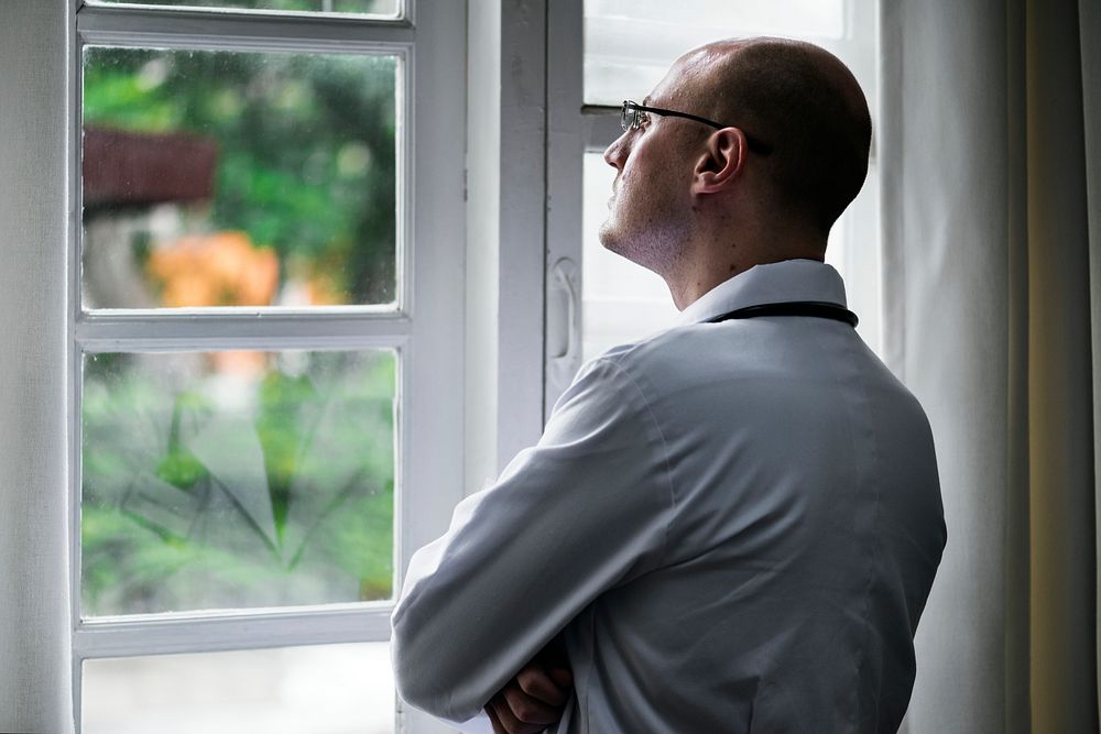 Caucasian male doctor thinking deeply | Premium Photo - rawpixel
