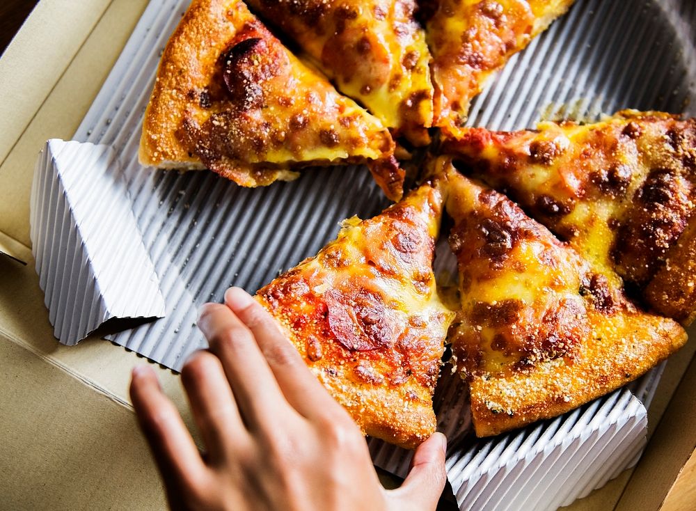 Hand grabbing delivered pizza | Premium Photo - rawpixel