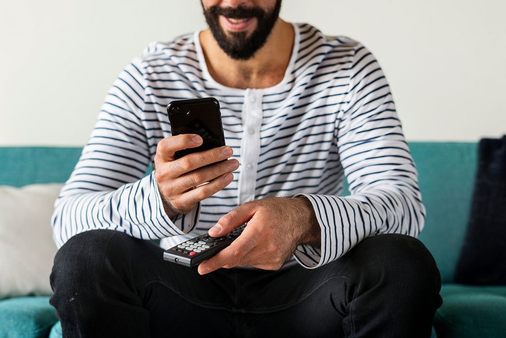 Man using device on couch | Free Photo - rawpixel