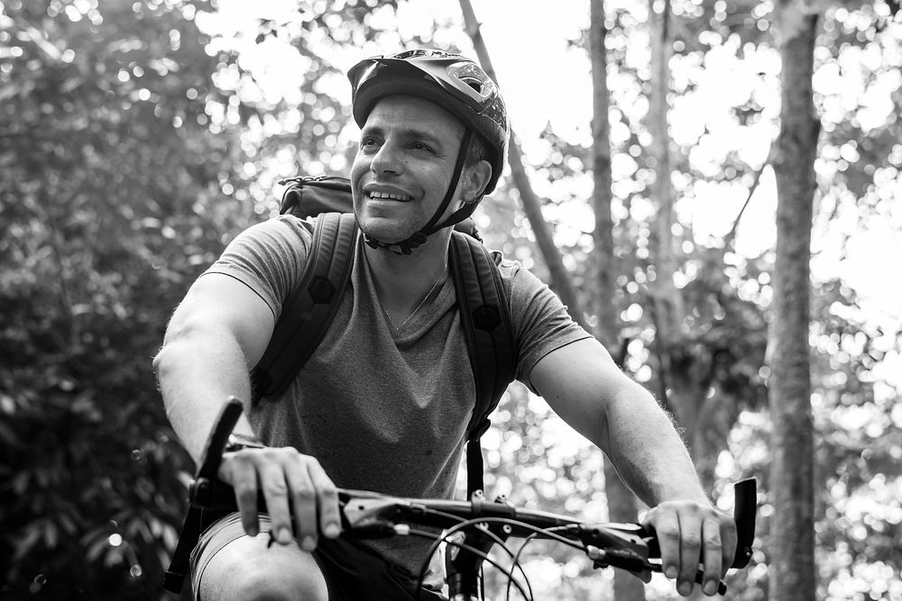 Happy cyclist riding through the forest | Free Photo - rawpixel
