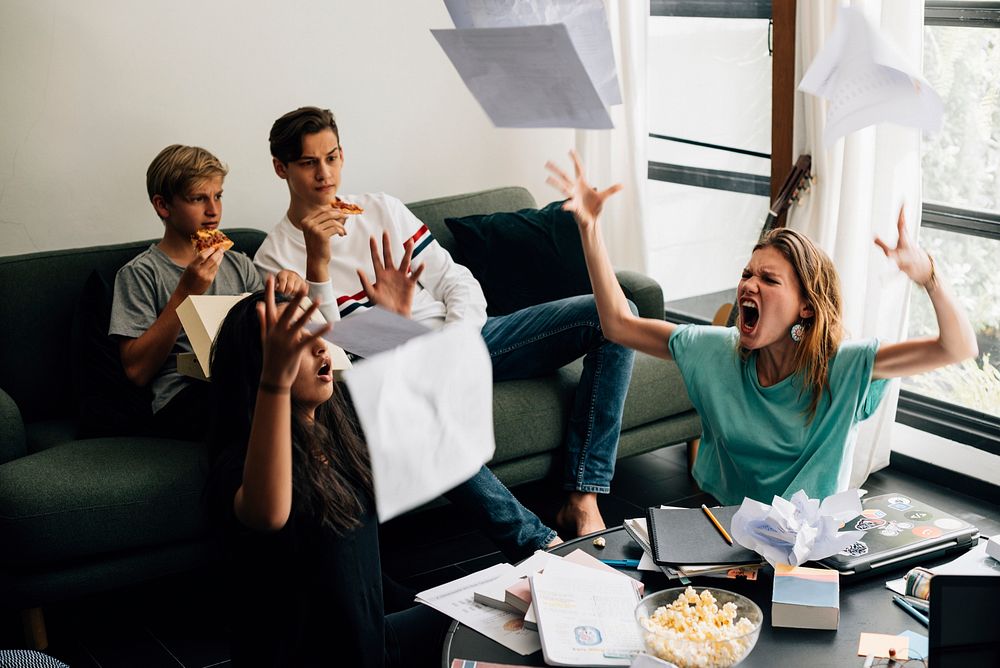 Young girl throwing papers in the air | Photo - rawpixel