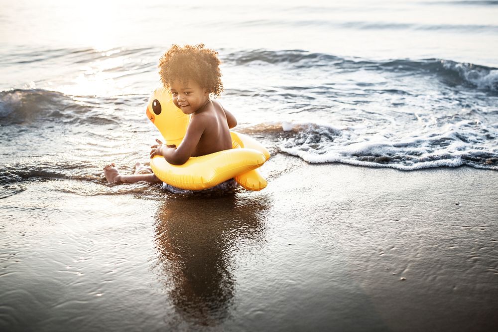 Cute toddler duck tube beach | Free Photo - rawpixel