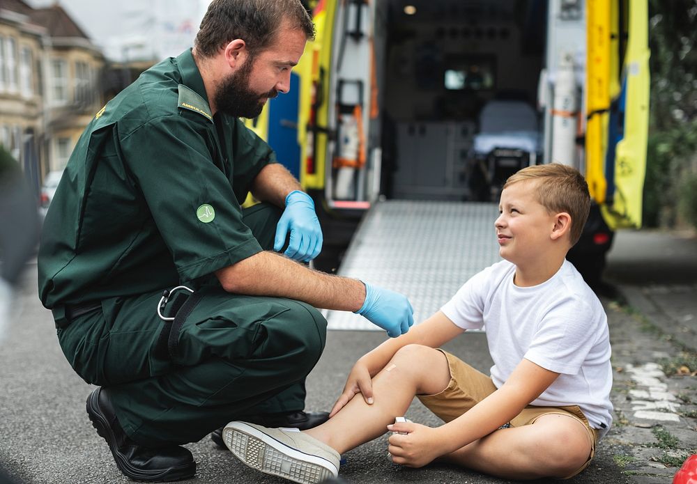 Injured boy getting help from paramedics | Premium Photo - rawpixel