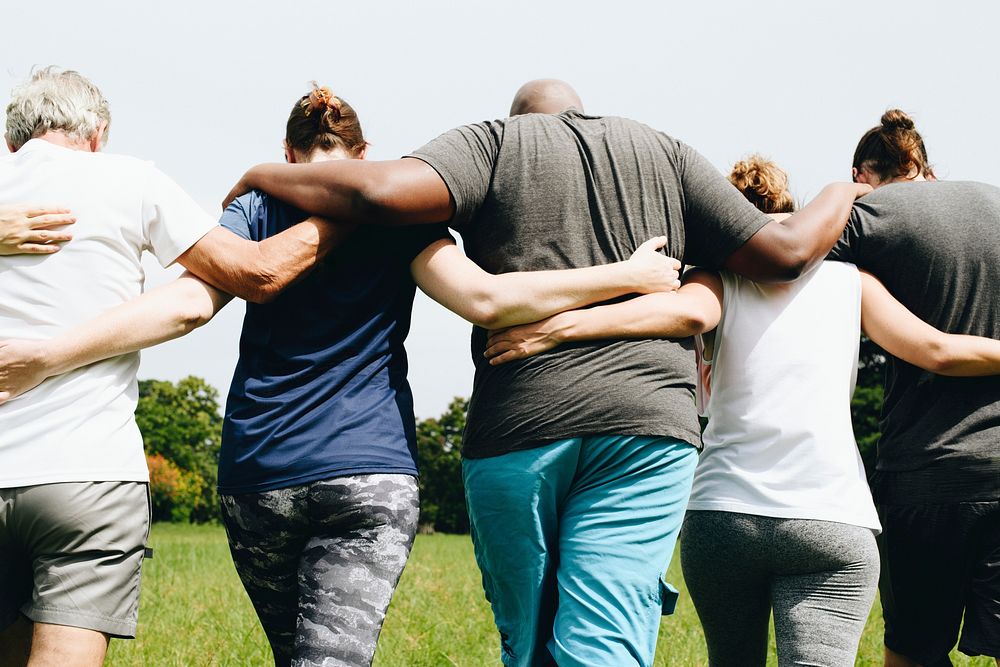 Group of people hugging in the park | Photo - rawpixel