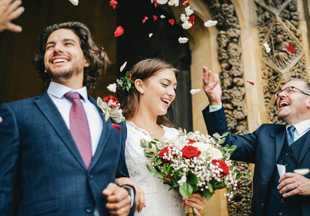 Family throwing rose petals at the newly | Photo - rawpixel