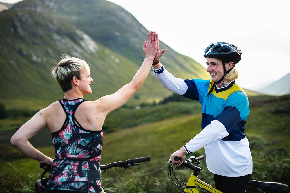 Cyclists giving each other a high | Premium Photo - rawpixel