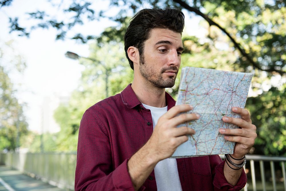 Man using map downtown park | Premium Photo - rawpixel