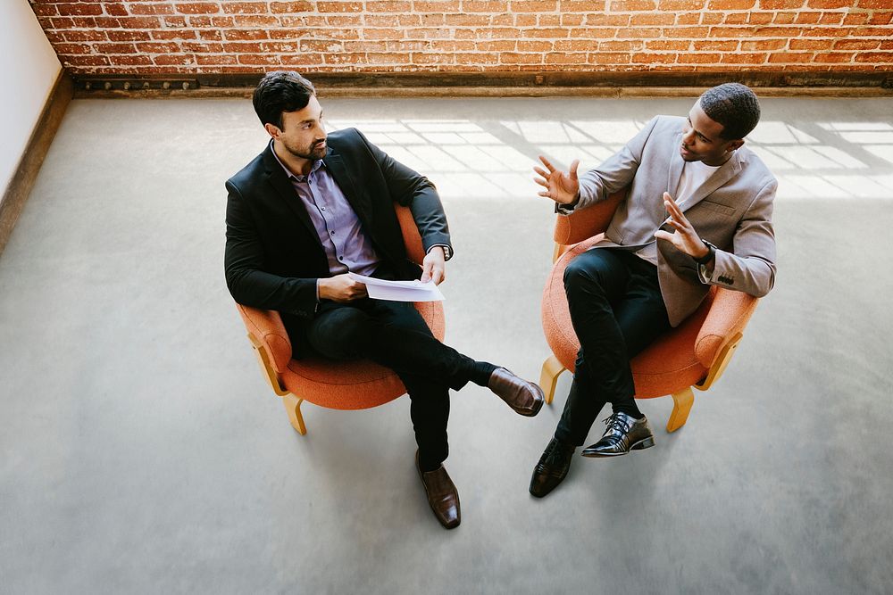 Businessmen talking and sitting chairs | Premium Photo - rawpixel