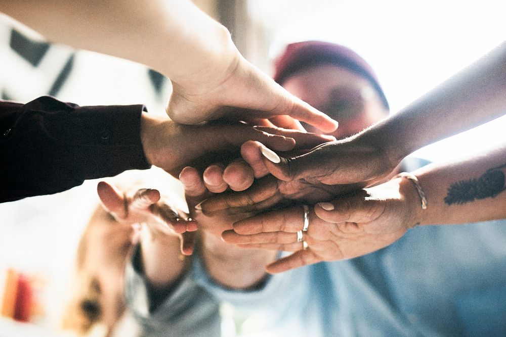 Happy team putting their hands | Premium Photo - rawpixel