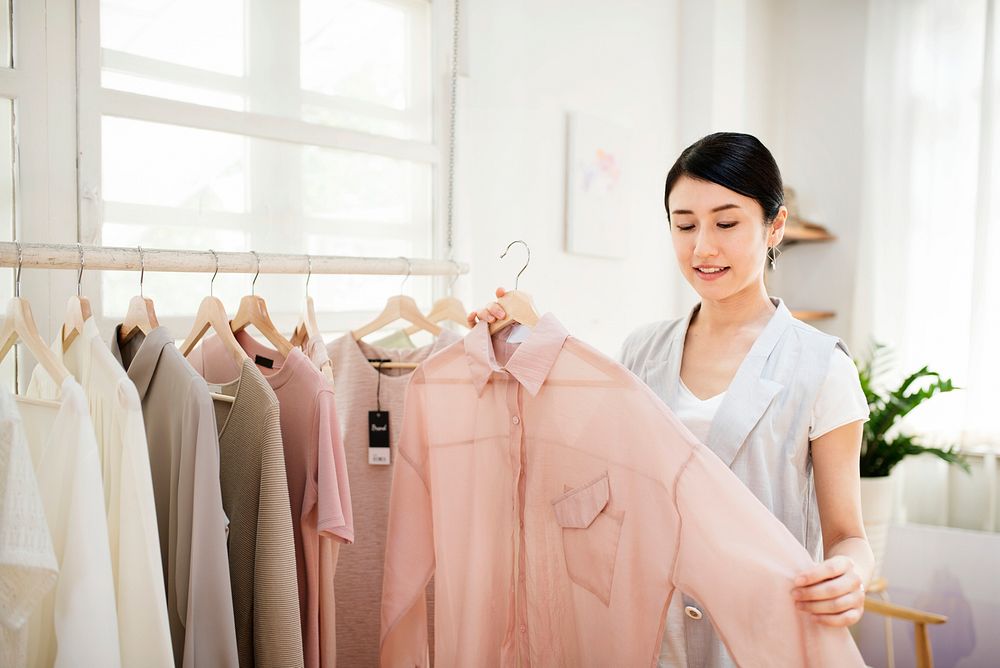 A stylist is choosing cloth | Premium Photo - rawpixel