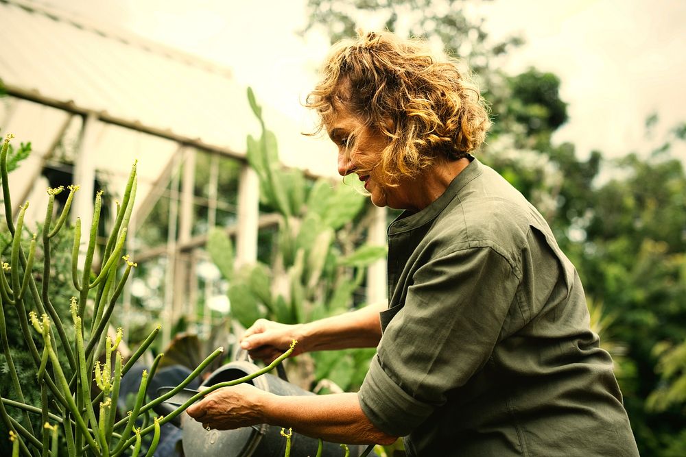 Woman gardening in her greenhouse | Photo - rawpixel