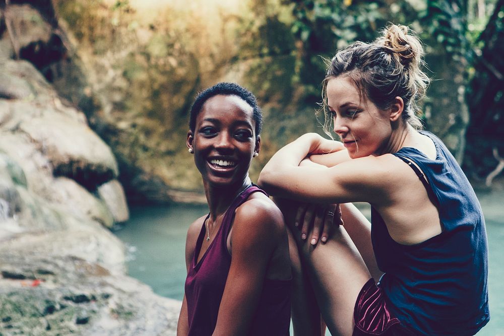 Two friends relaxing by a waterfall | Photo - rawpixel