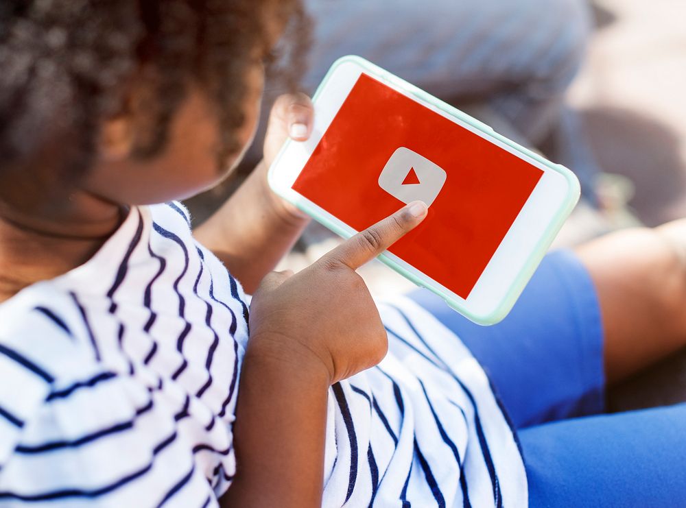 Young kid using Youtube application. | Free Photo - rawpixel