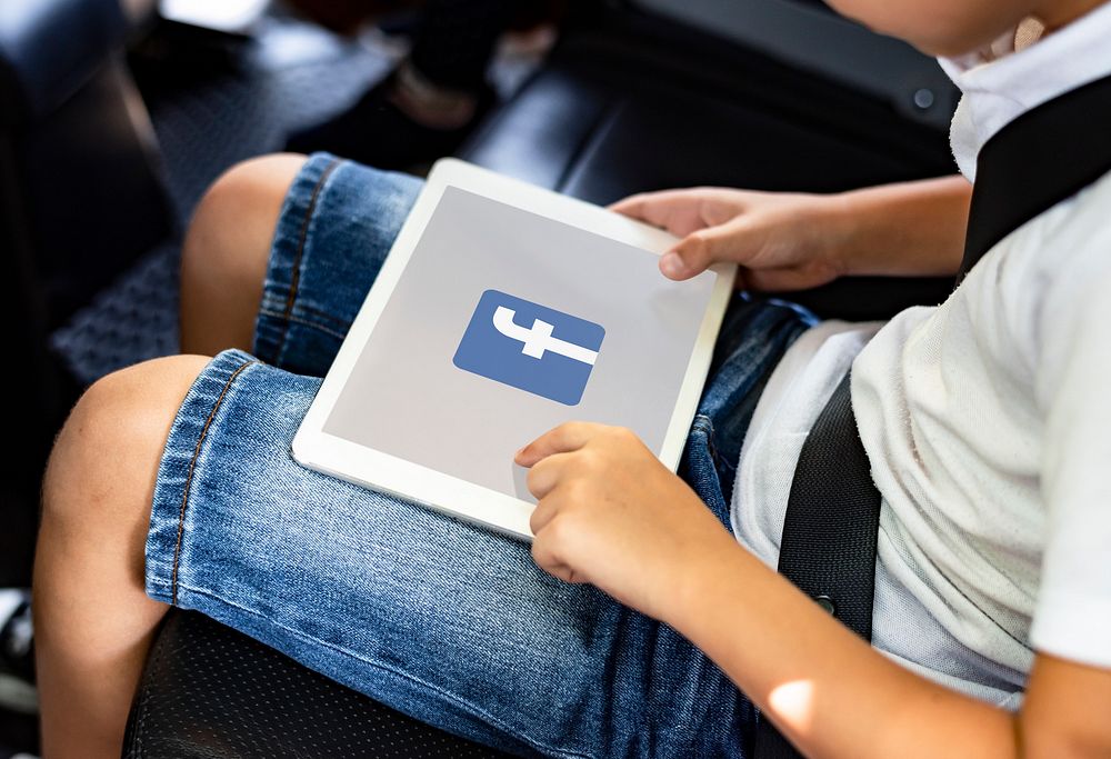 Boy sitting car using Facebook | Free Photo - rawpixel