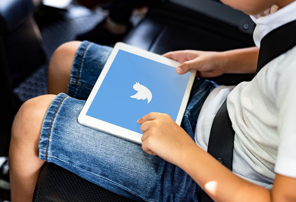Boy playing Twitter digital tablet | Free Photo - rawpixel