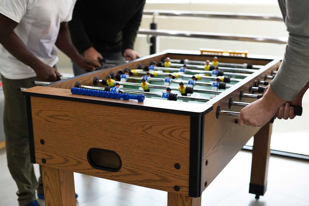 Group of guys playing foosball | Premium Photo - rawpixel