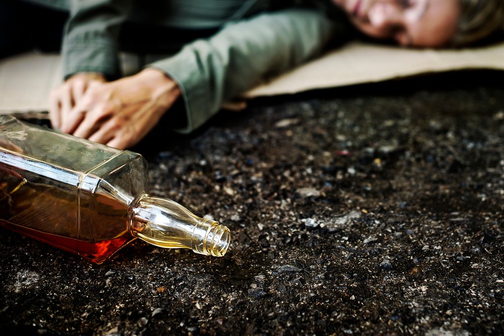 Homeless woman with an alcohol | Photo - rawpixel