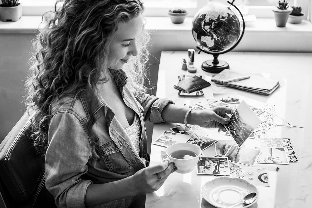 Caucasian woman looking at photos | Free Photo - rawpixel