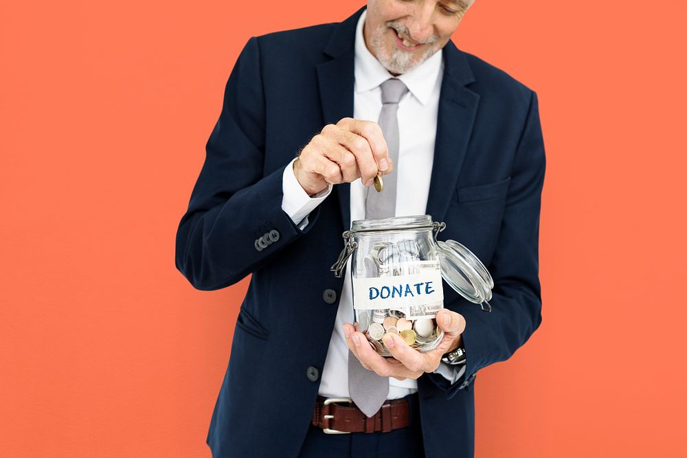 Businessman donating in a jar | Premium Photo - rawpixel