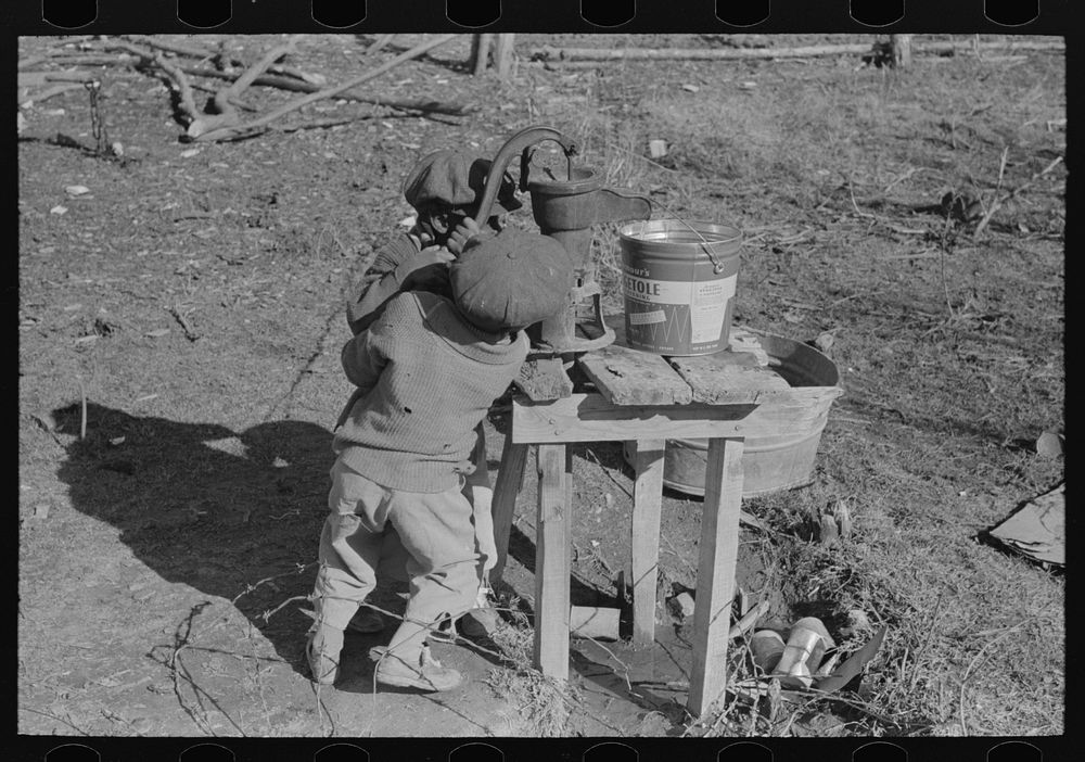 Children sharecropper pumping water. Family | Free Photo - rawpixel