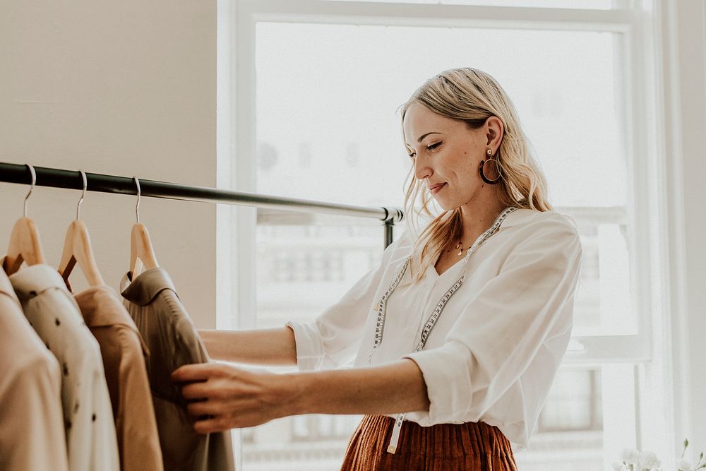 Fashion stylist sorting clothing rack | Premium Photo - rawpixel