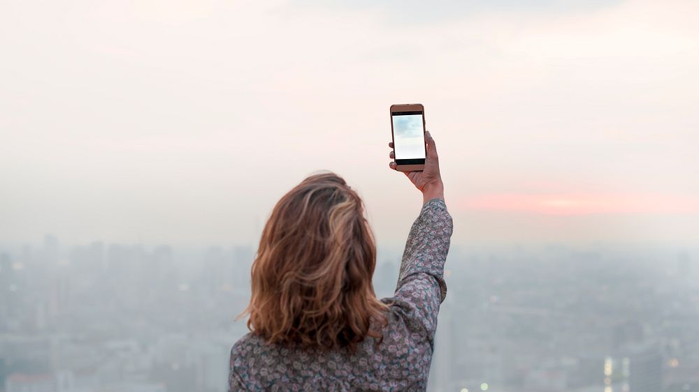 Woman capturing a photo of the sunset | Premium Photo - rawpixel