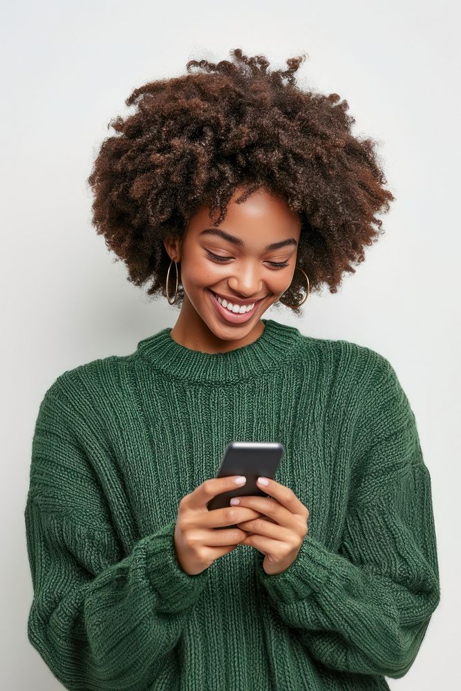 Black woman looking phone sweater | Free Photo - rawpixel