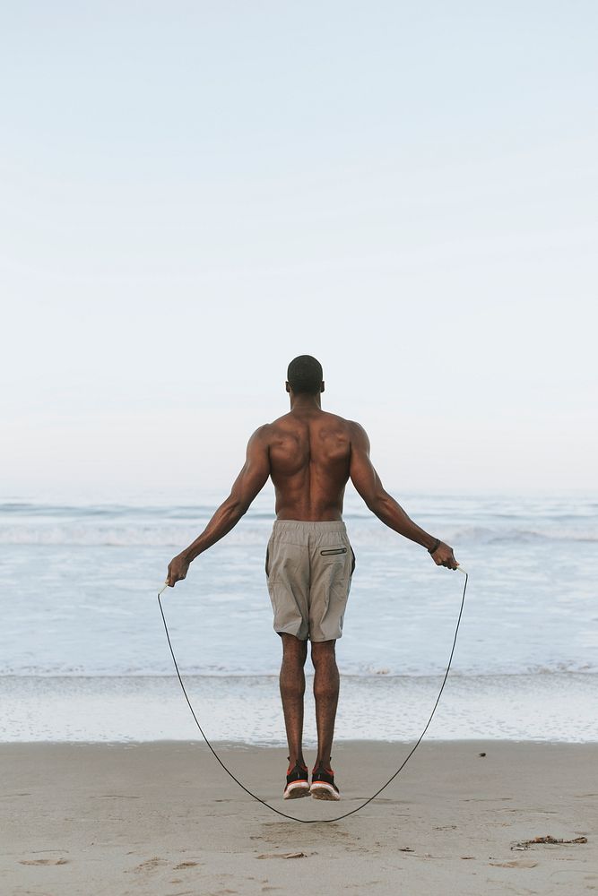 Fit man jumping rope beach | Premium Photo - rawpixel
