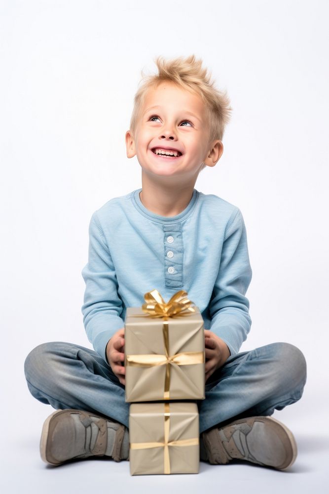 Holding gift boxes child sitting | Free Photo - rawpixel