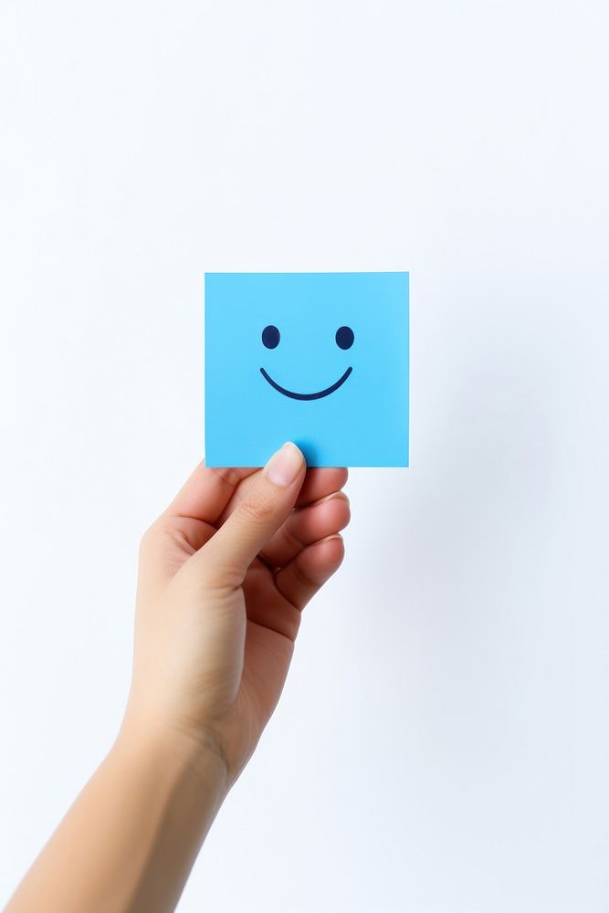 Smile face paper holding symbol. | Free Photo - rawpixel
