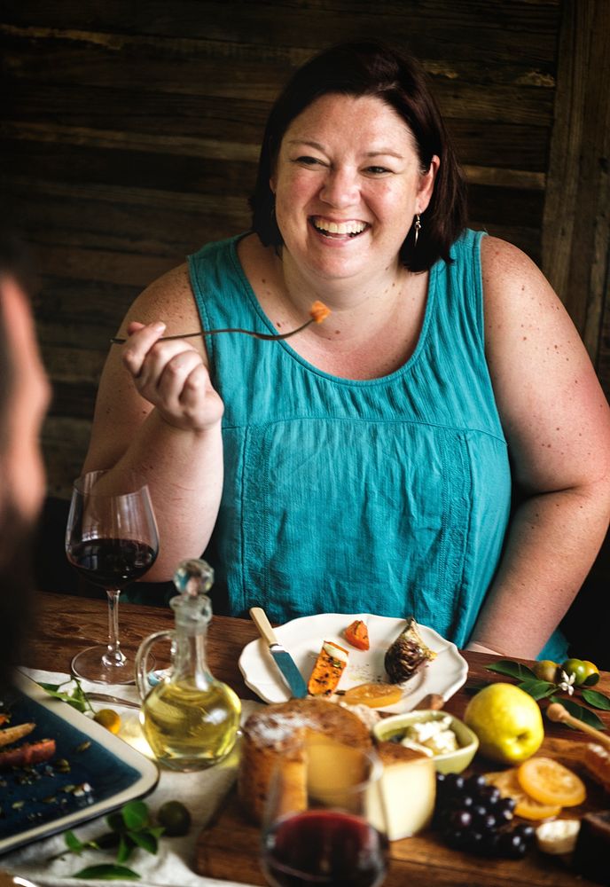 Woman enjoying a cheese platter | Premium Photo - rawpixel