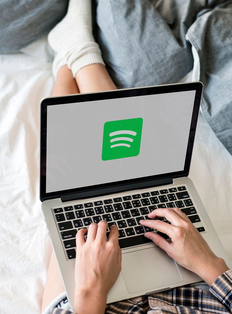 A woman using Spotify on a laptop. | Free Photo - rawpixel