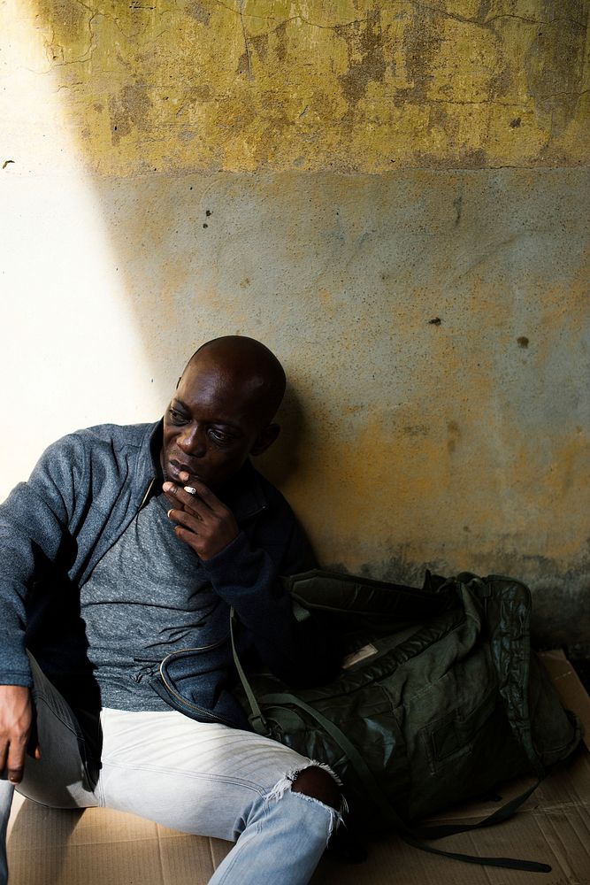 Homeless man alone on the street | Photo - rawpixel