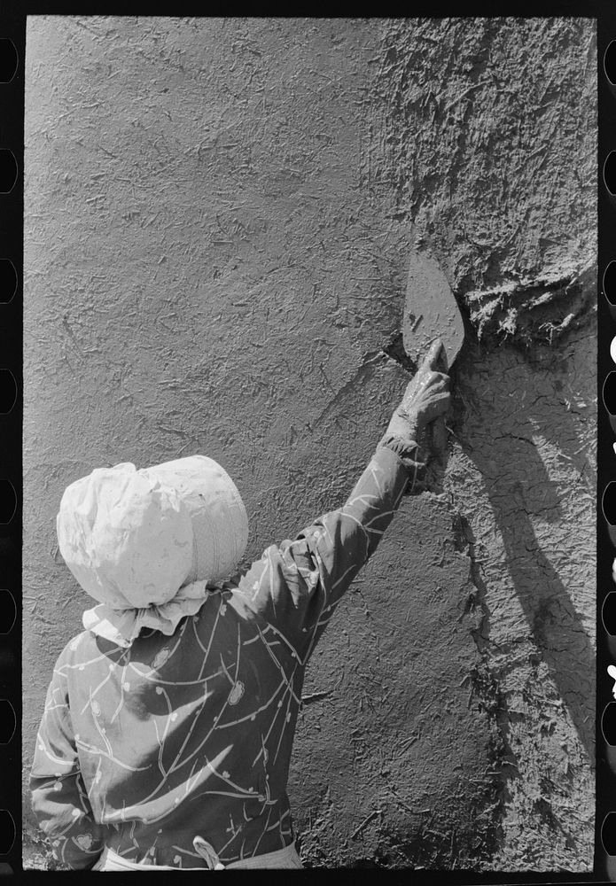 Spanish-American woman plastering adobe house, | Free Photo - rawpixel