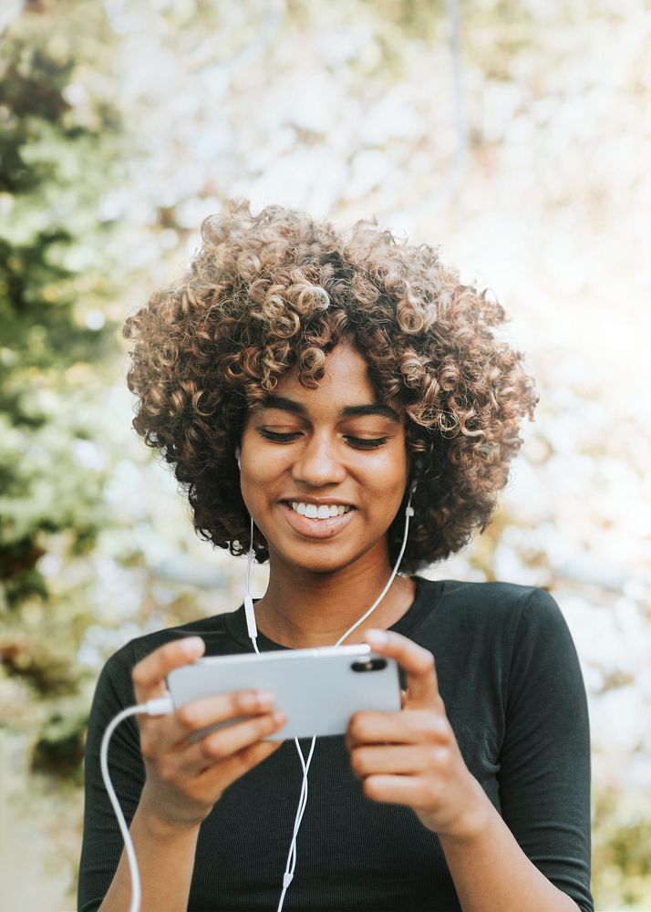 Beautiful woman using smartphone garden | Free Photo - rawpixel