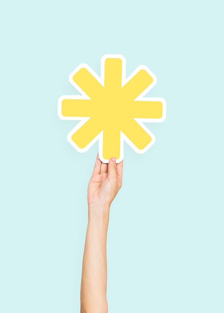 Hand holding an asterisk sign | Free Photo - rawpixel