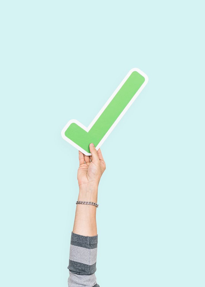 Hand holding a check mark | Premium PSD - rawpixel