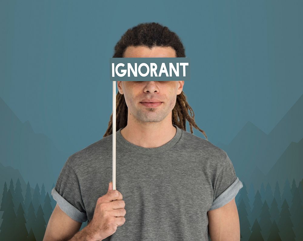 Man holding 'ignorant' sign. | Free Photo - rawpixel