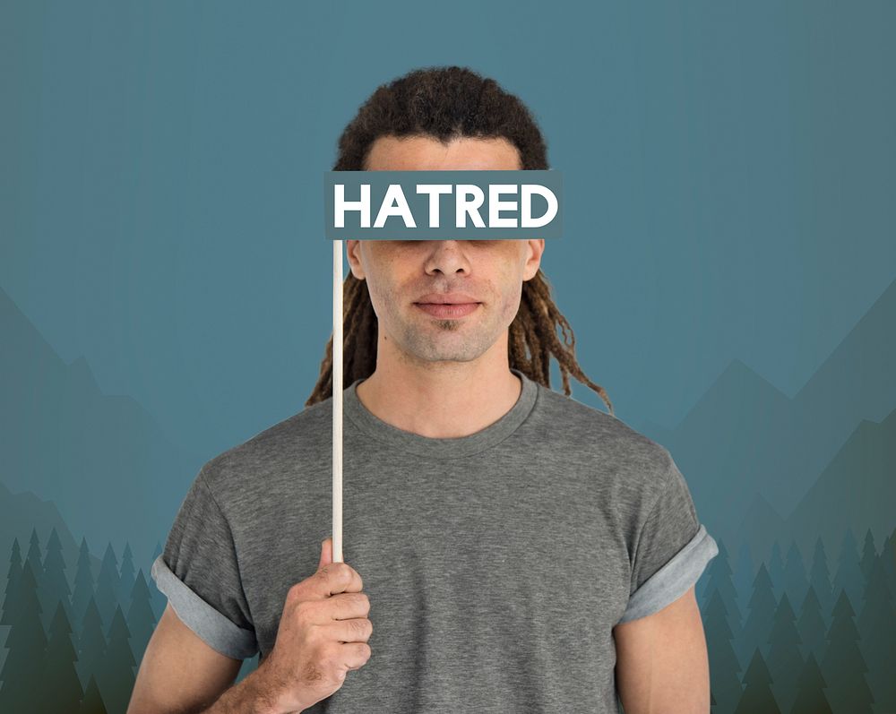 Man holding 'hatred' sign. | Free Photo - rawpixel