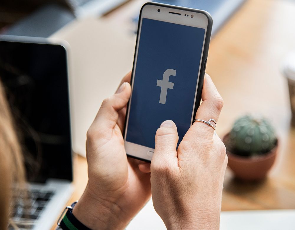 Woman using Facebook application smartphone. | Free Photo - rawpixel