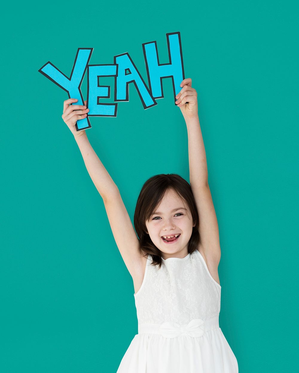 Cheerful girl holding YEAH paper | Premium Photo - rawpixel